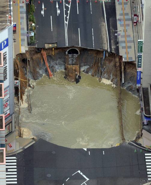 World News: In Pictures: Parts of street collapse in southern Japan ...