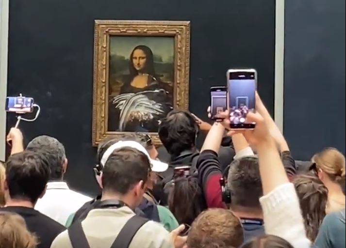 OMG: WATCH: Mona Lisa gets caked by man disguised as old woman